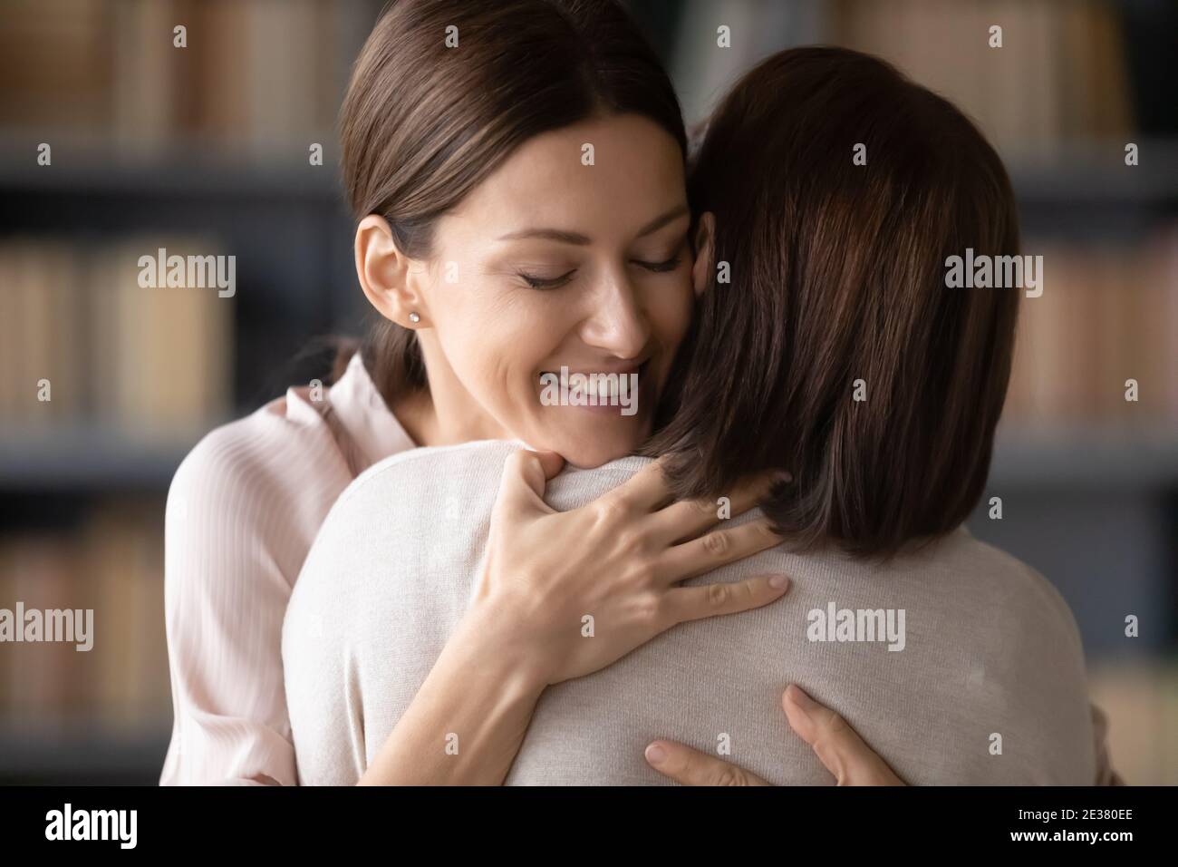 Close up loving smiling young woman hugging mature mother Stock Photo ...