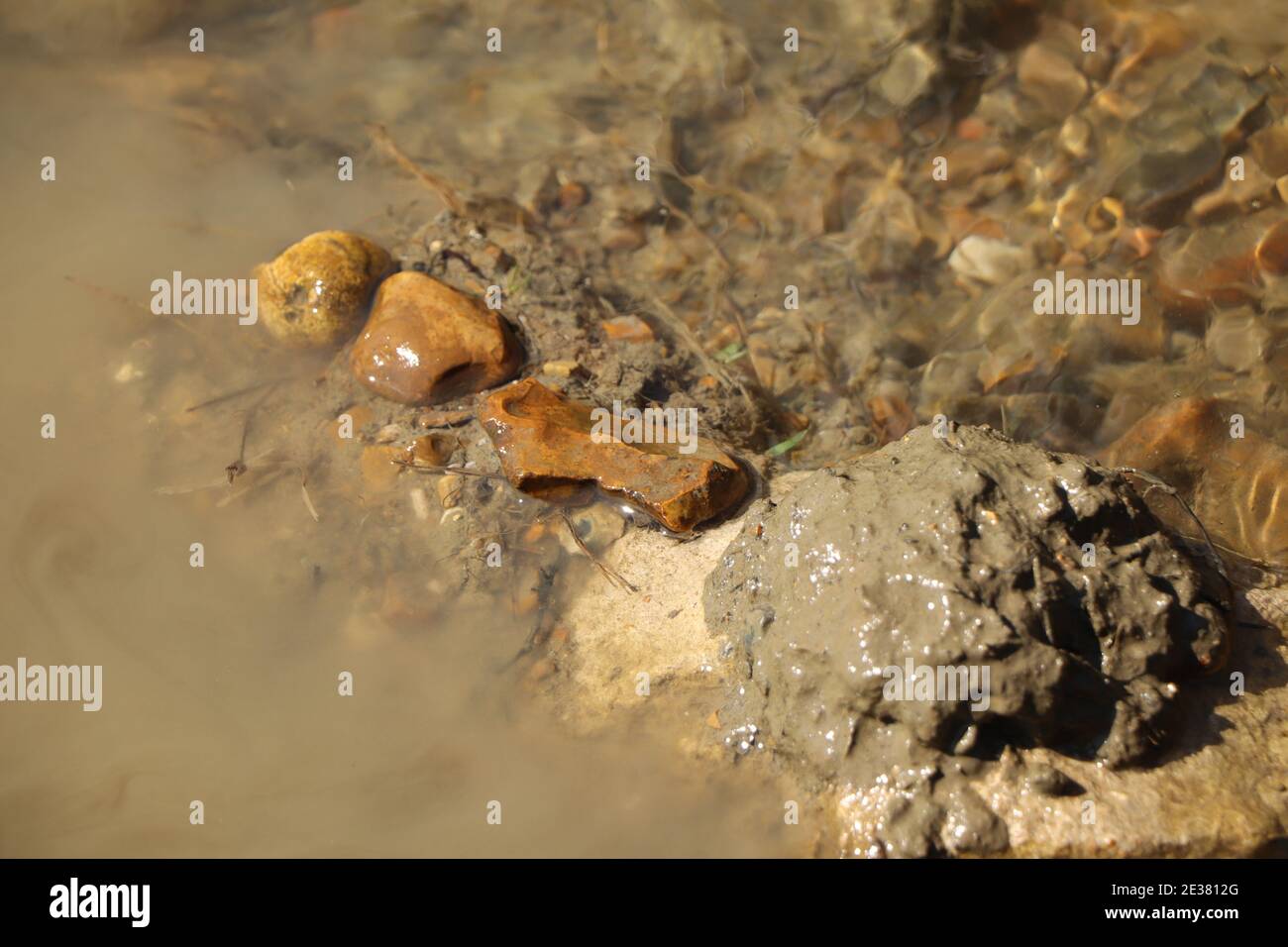 Ground level close up of mud and water sloshing down a stream Stock ...