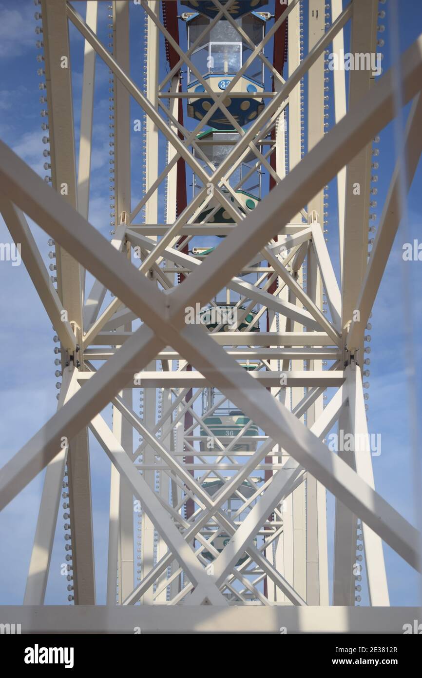 Ferris wheel construction seen from one of the cabins. Part of a white ...