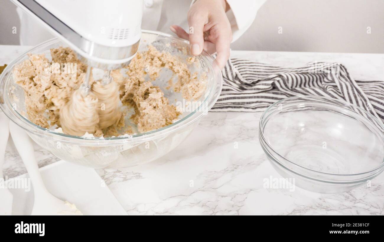 Step by step. Mixing ingredients in a glass bowl to make chocolate chip ...