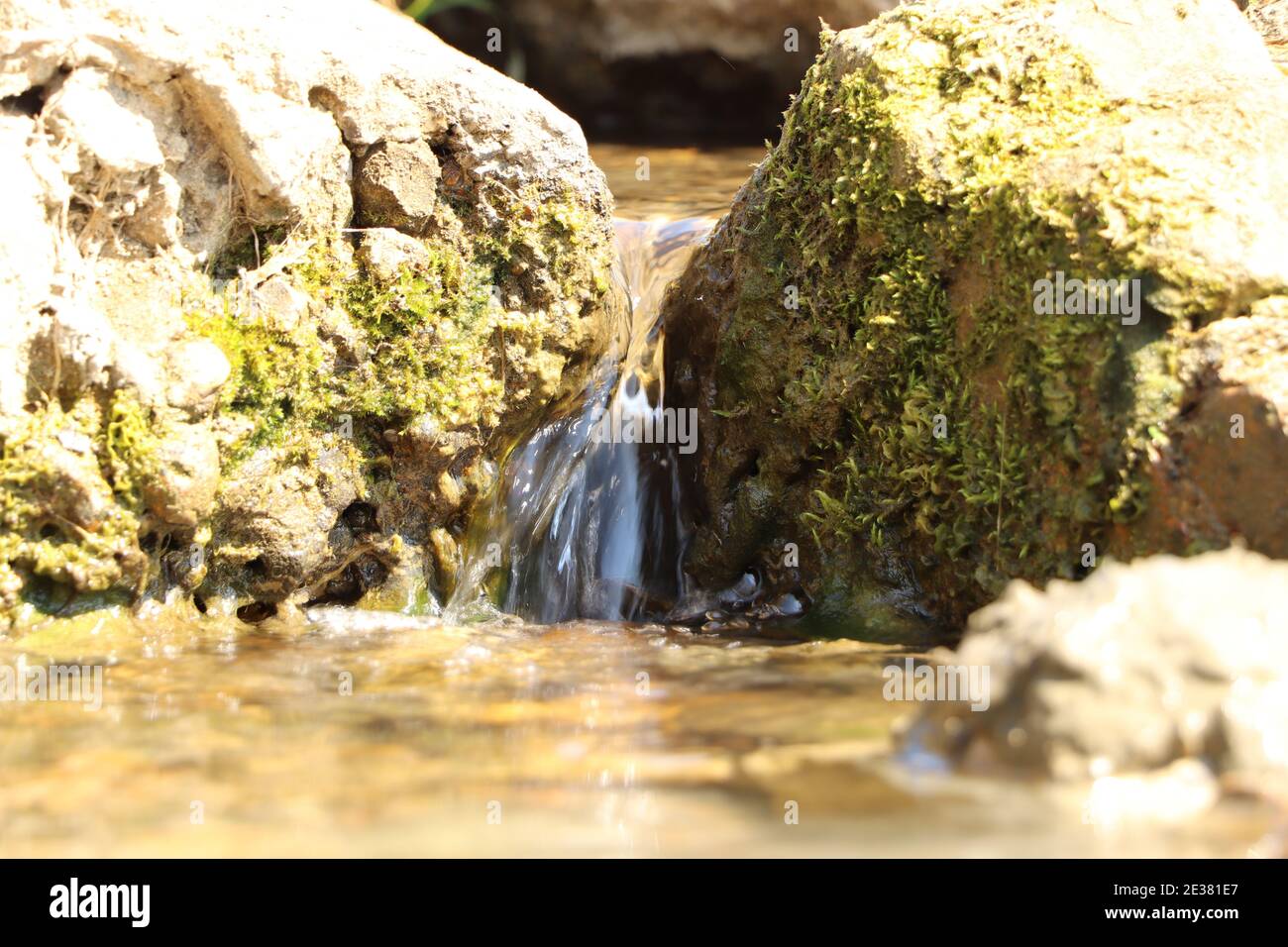 Ground level close up of mud and water sloshing down a stream Stock ...