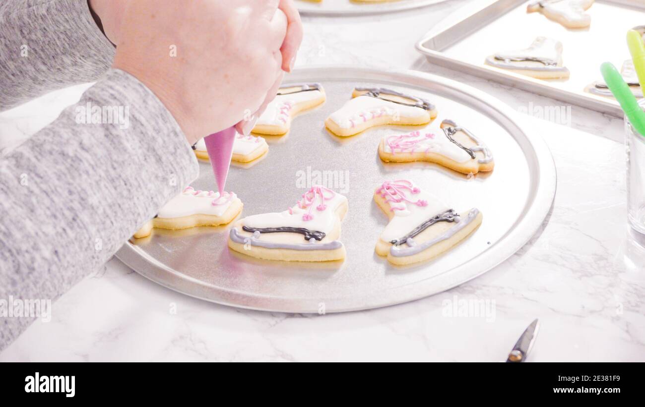 Icing figure skate shaped sugar cookies with royal icing Stock Photo ...