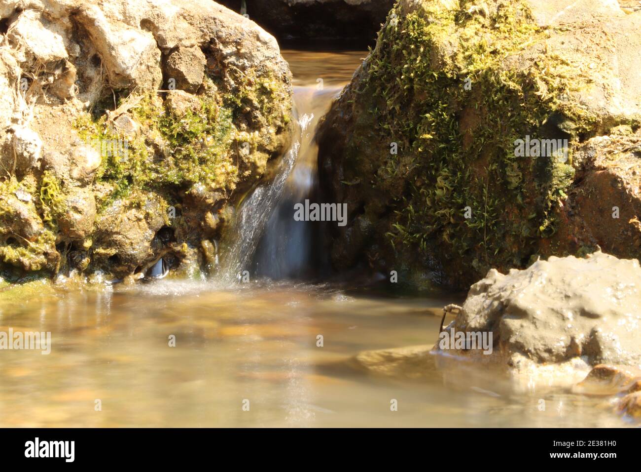 Ground level close up of mud and water sloshing down a stream Stock ...