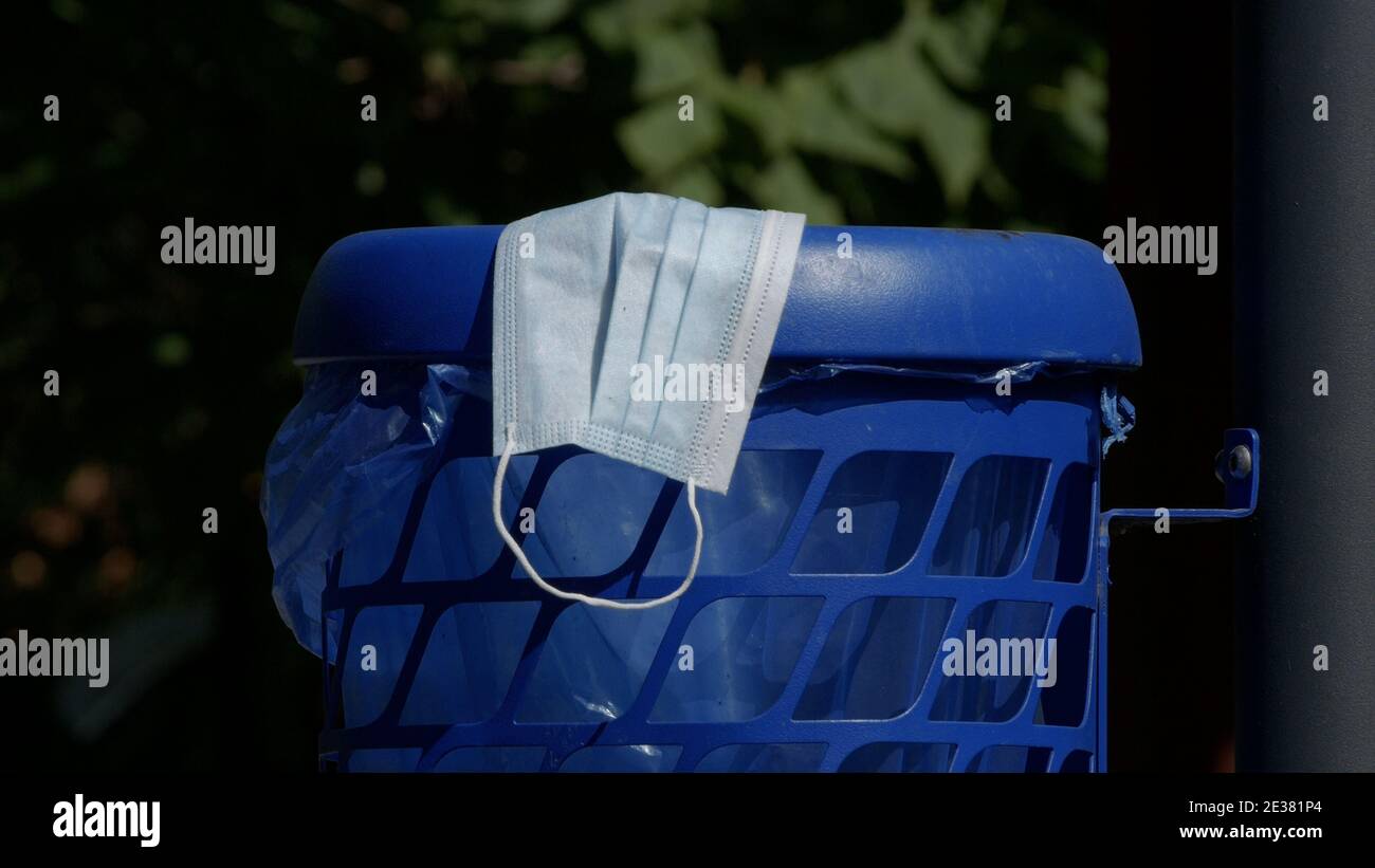 Used Medical Face Mask Thrown in the Trash Can on the Street, Dangerous ...