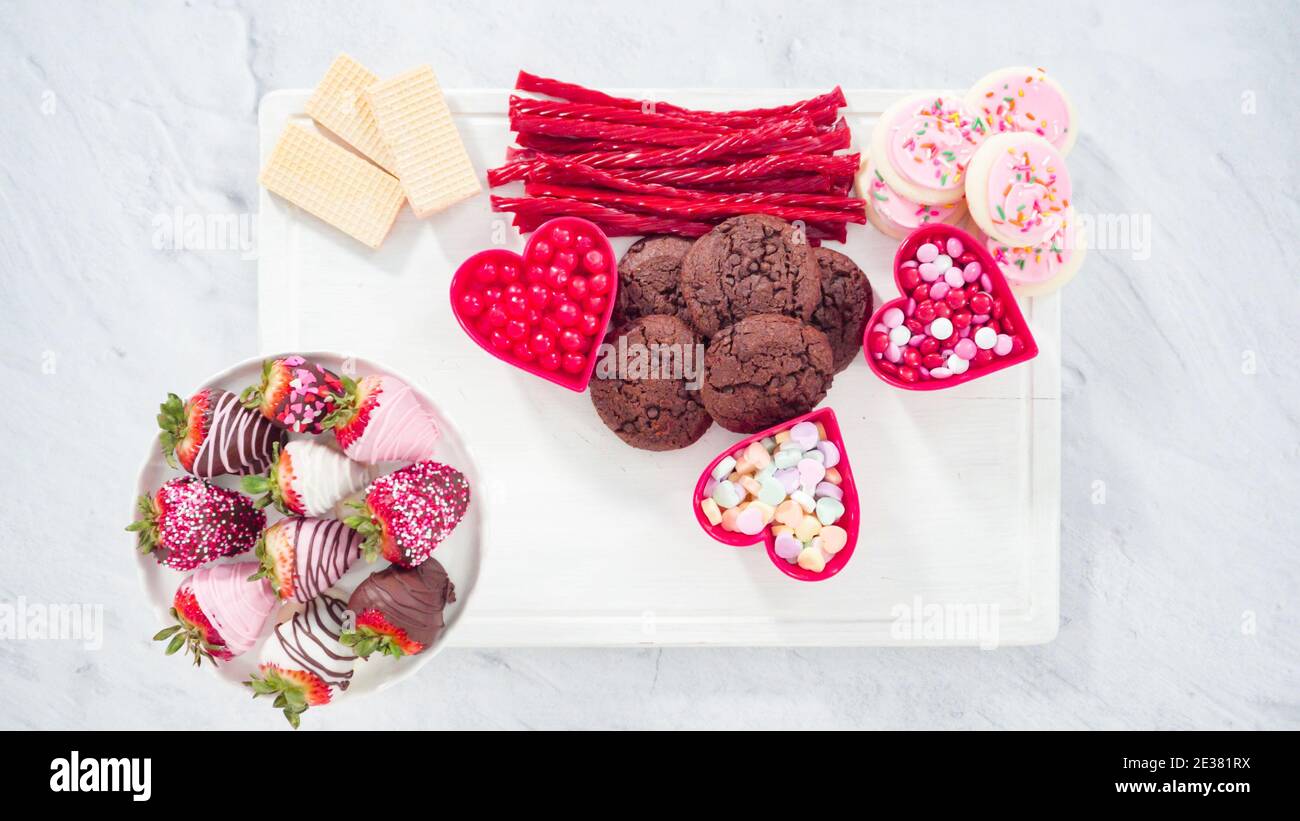 Flat lay. Step by step. Cheese board with candies and cookies for ...