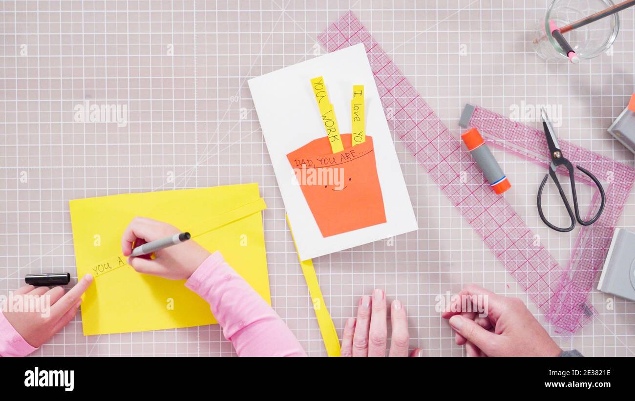 Flat lay. Little girl making a handmade Father's Day card from ...