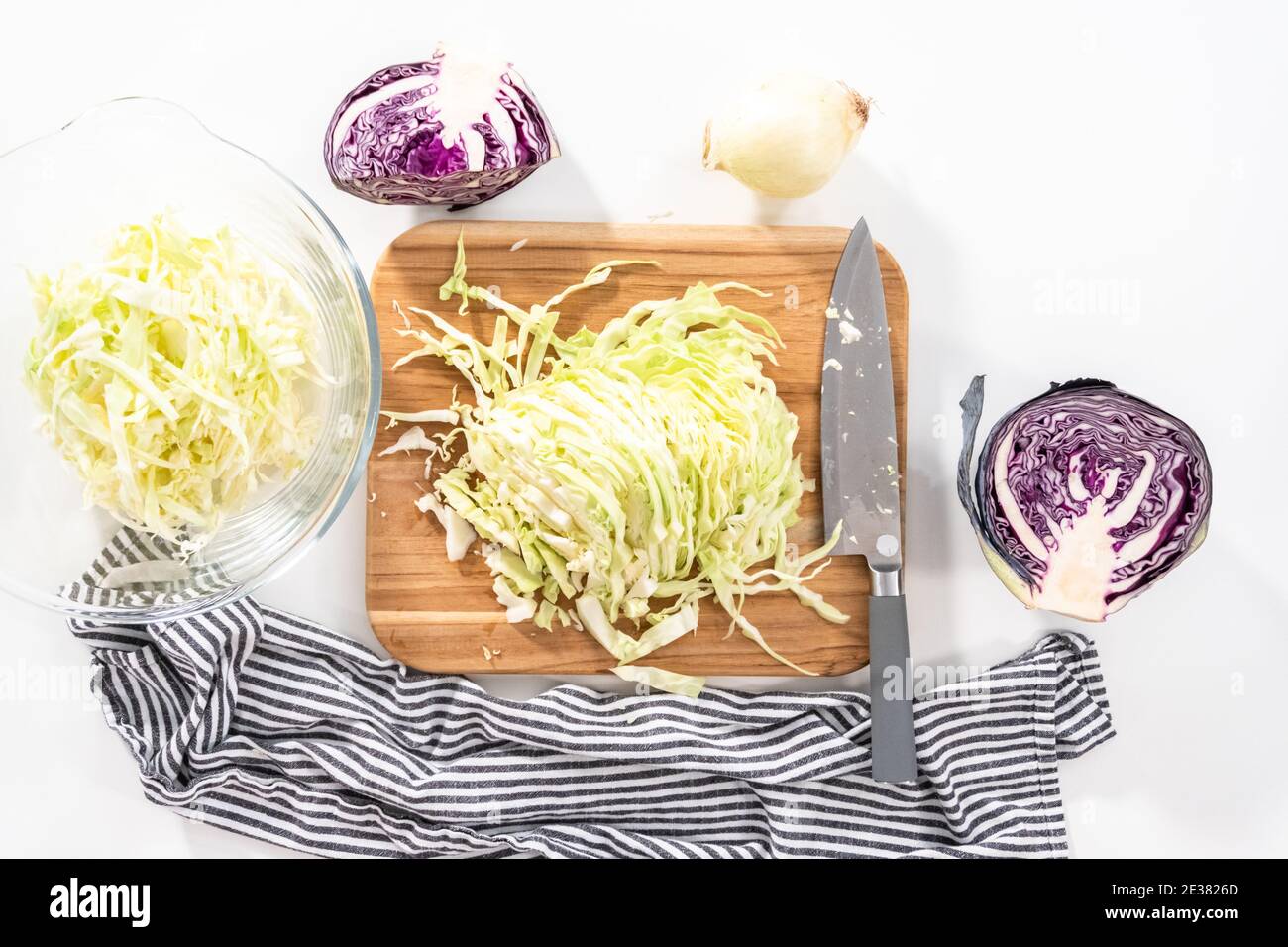 Flat lay. Shredding green cabbage on a wood cutting board Stock Photo ...
