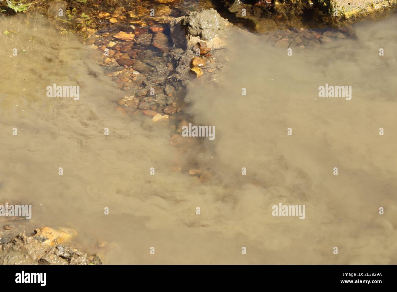 Ground level close up of mud and water sloshing down a stream Stock ...