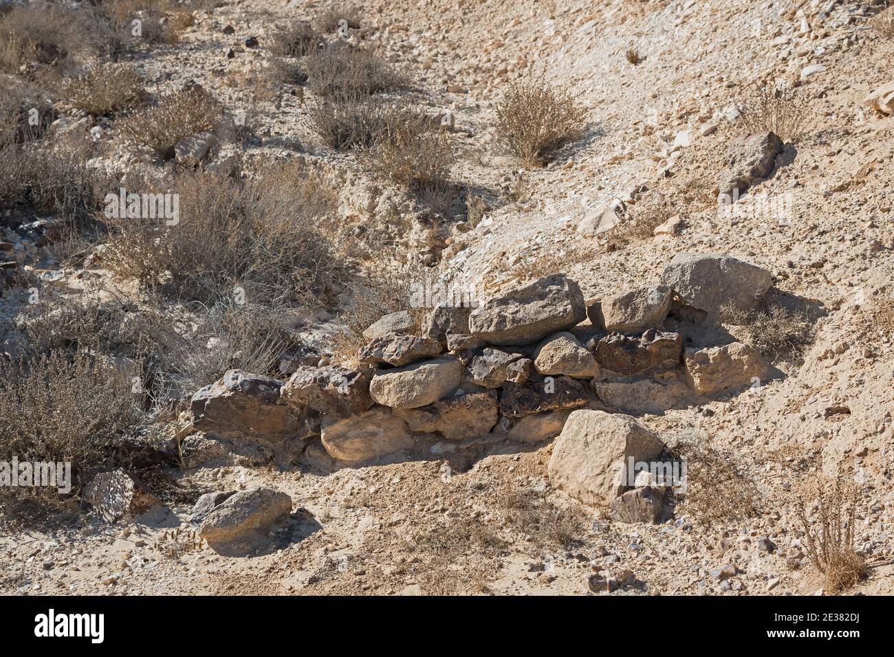 closeup of the ruins of a small crude possibly prehistoric neolithic stone age dam located in a ...