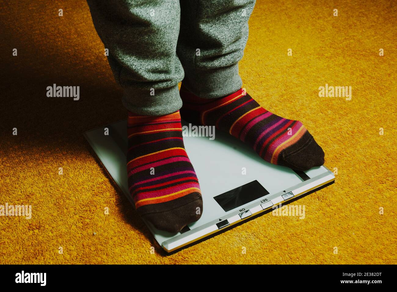 Man on scale feet hi-res stock photography and images - Alamy