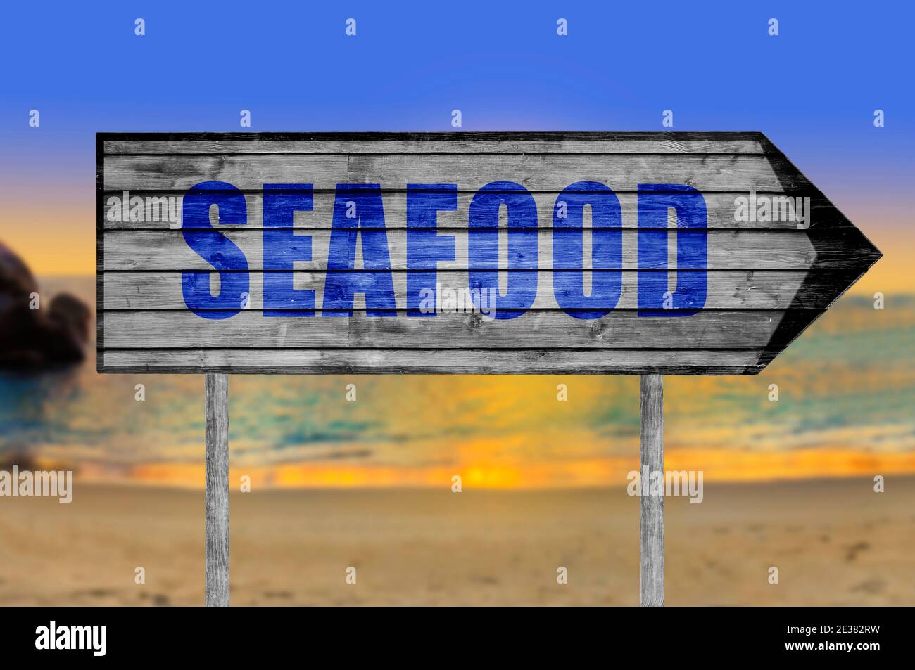 Seafood wooden sign with a beach on background Stock Photo - Alamy