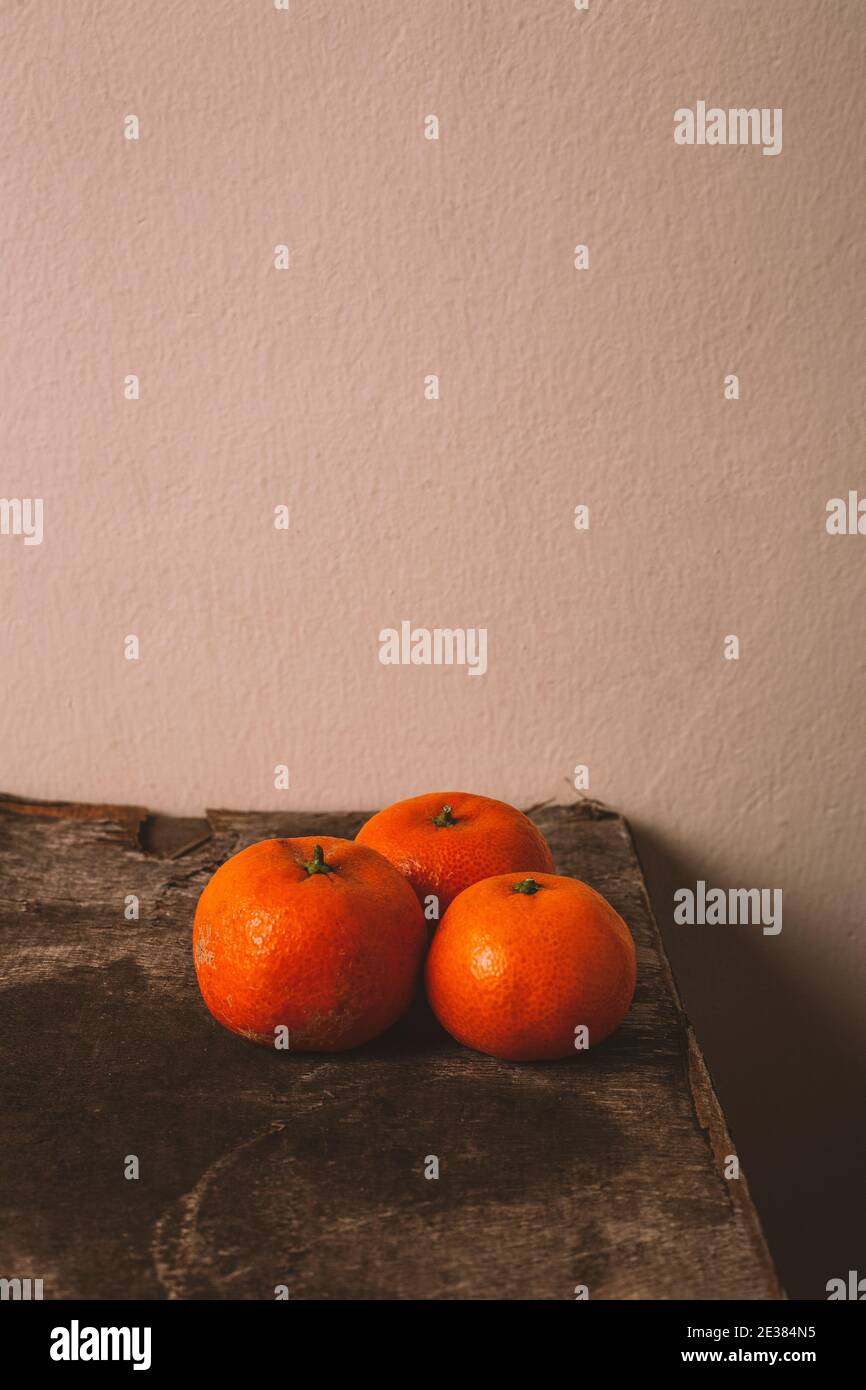 Tangerine, tangerine orange skin on old vintage table. Vertical picture ...