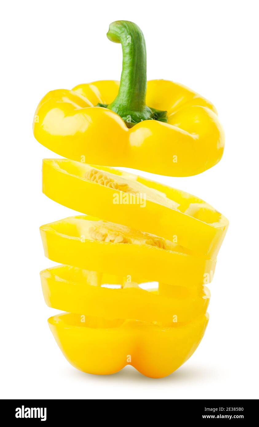 Yellow bell pepper cut into pieces falling close-up on a white ...