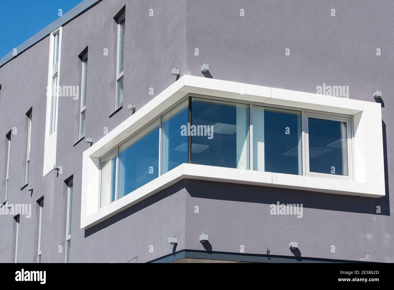 View of corner exterior facade of modern building. office building with ...