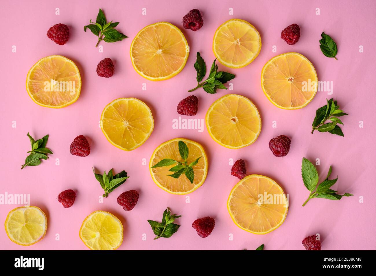 Lemon slices and strawberries on purple background Stock Photo - Alamy