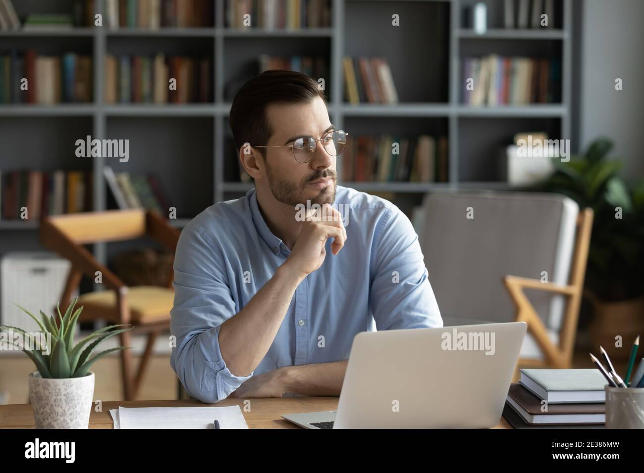 Distracted from work pensive young man looking in distance Stock Photo ...