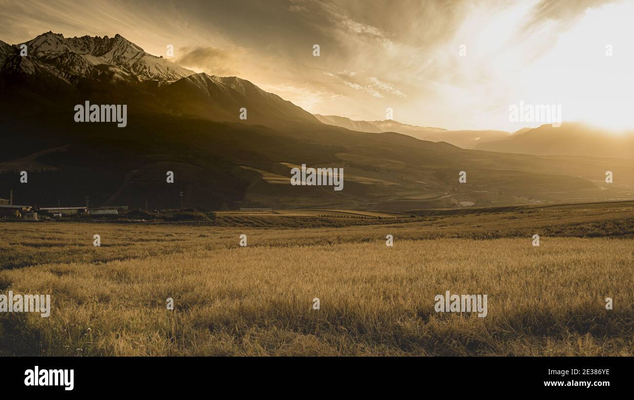 A beautiful landscape with fields and mountains at scenic sunset Stock ...