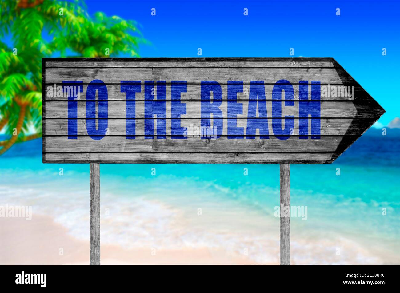 To The Beach wooden sign with on a beach background Stock Photo - Alamy