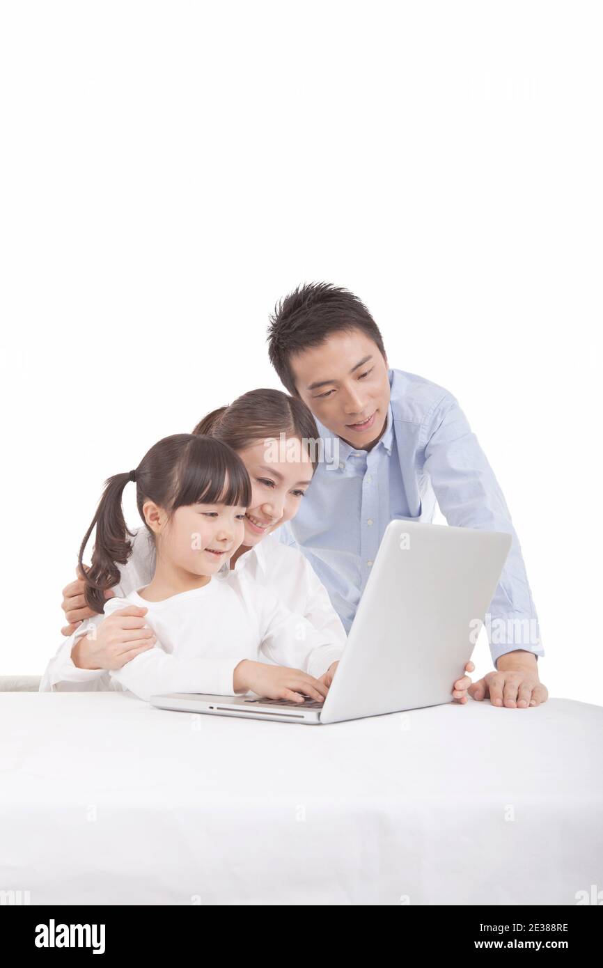 Portrait of daughter playing laptop with parents high quality photo ...