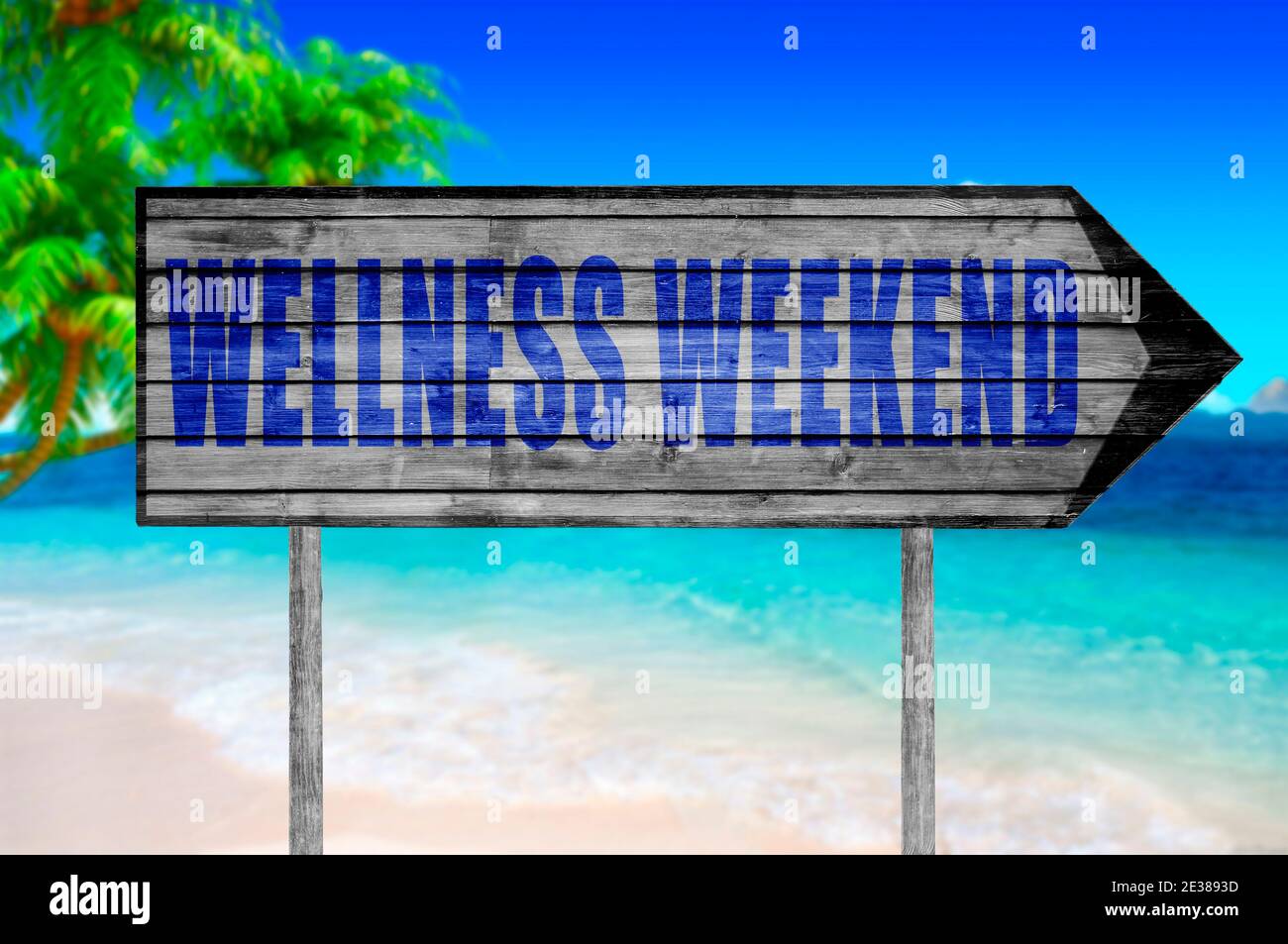 Wellness Weekend wooden sign with on a beach background Stock Photo - Alamy