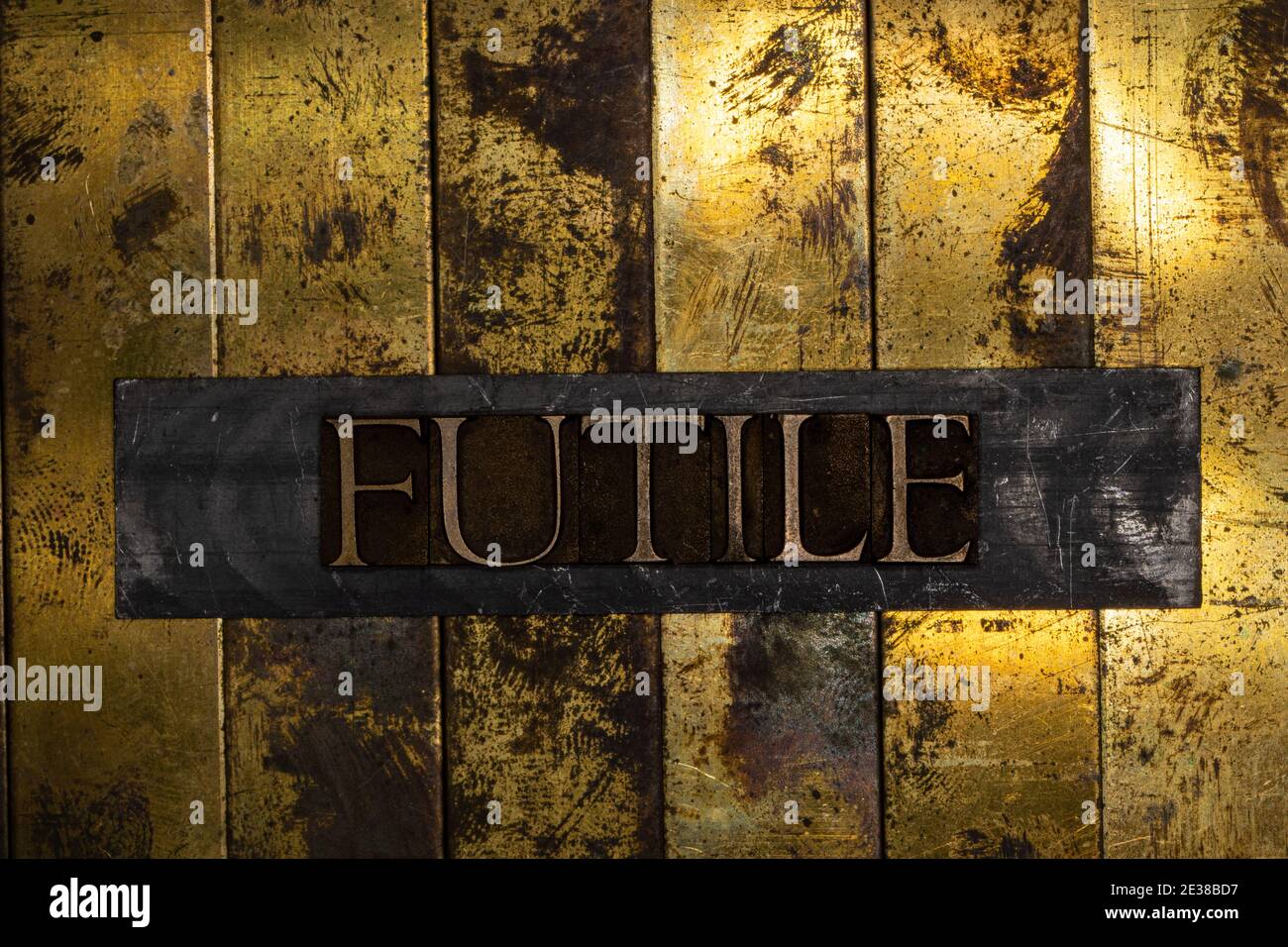Futile text on vintage textured grunge copper and gold background Stock ...