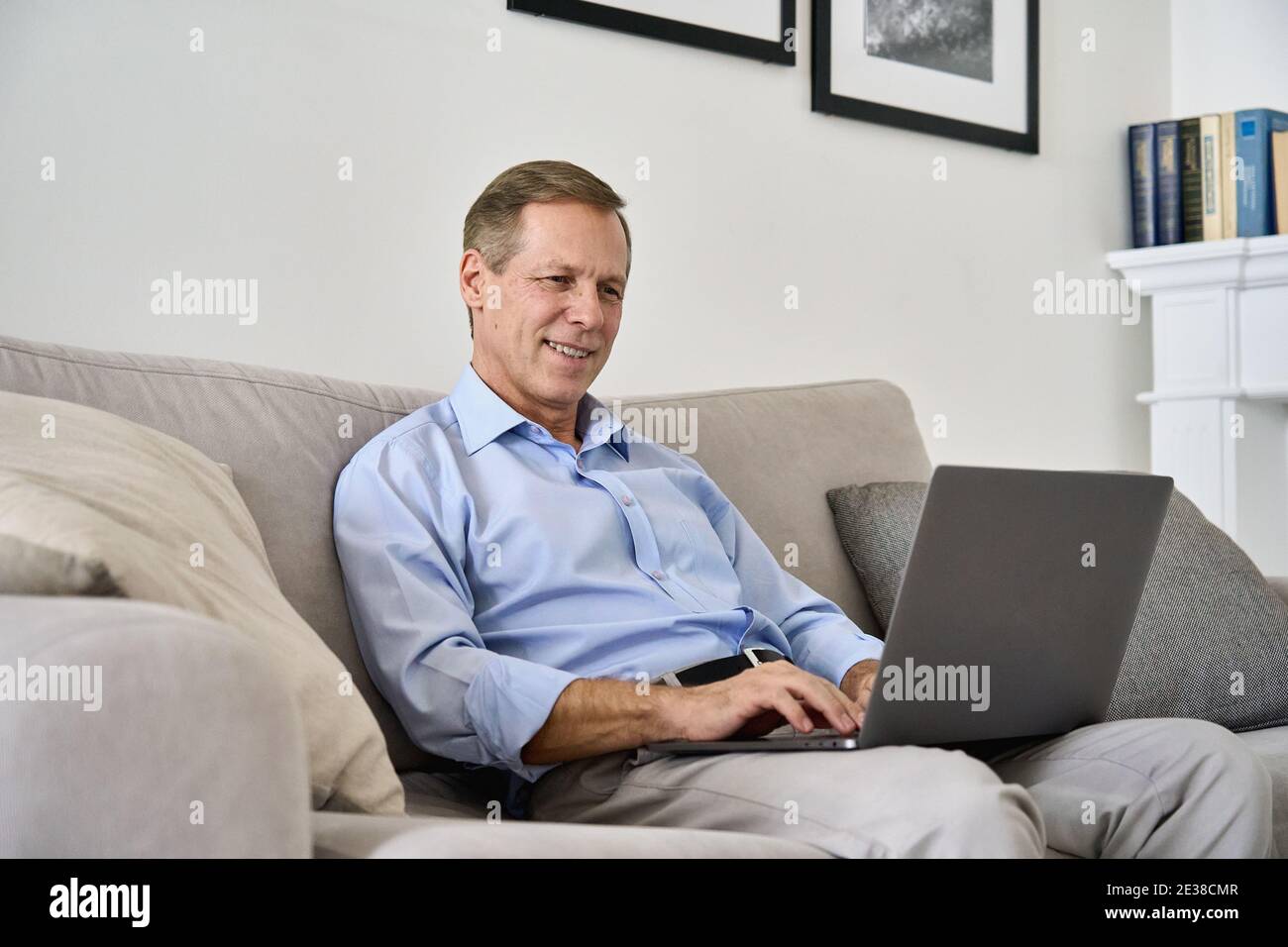 Mature man at home using laptop hi-res stock photography and images - Alamy