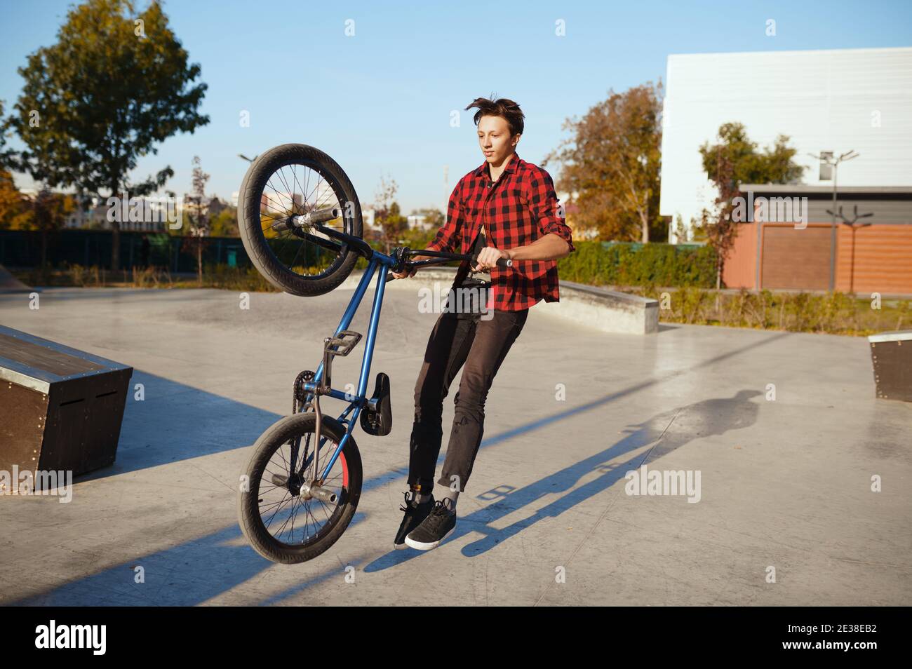 Male bmx biker doing trick, training in skatepark Stock Photo - Alamy