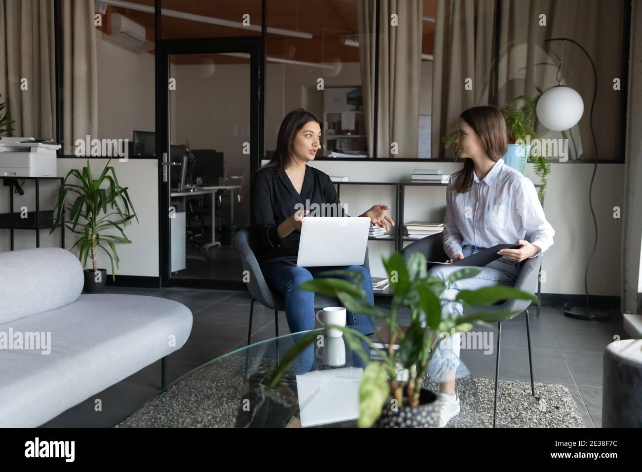 Diverse colleagues working together, discussing project, sharing ideas ...