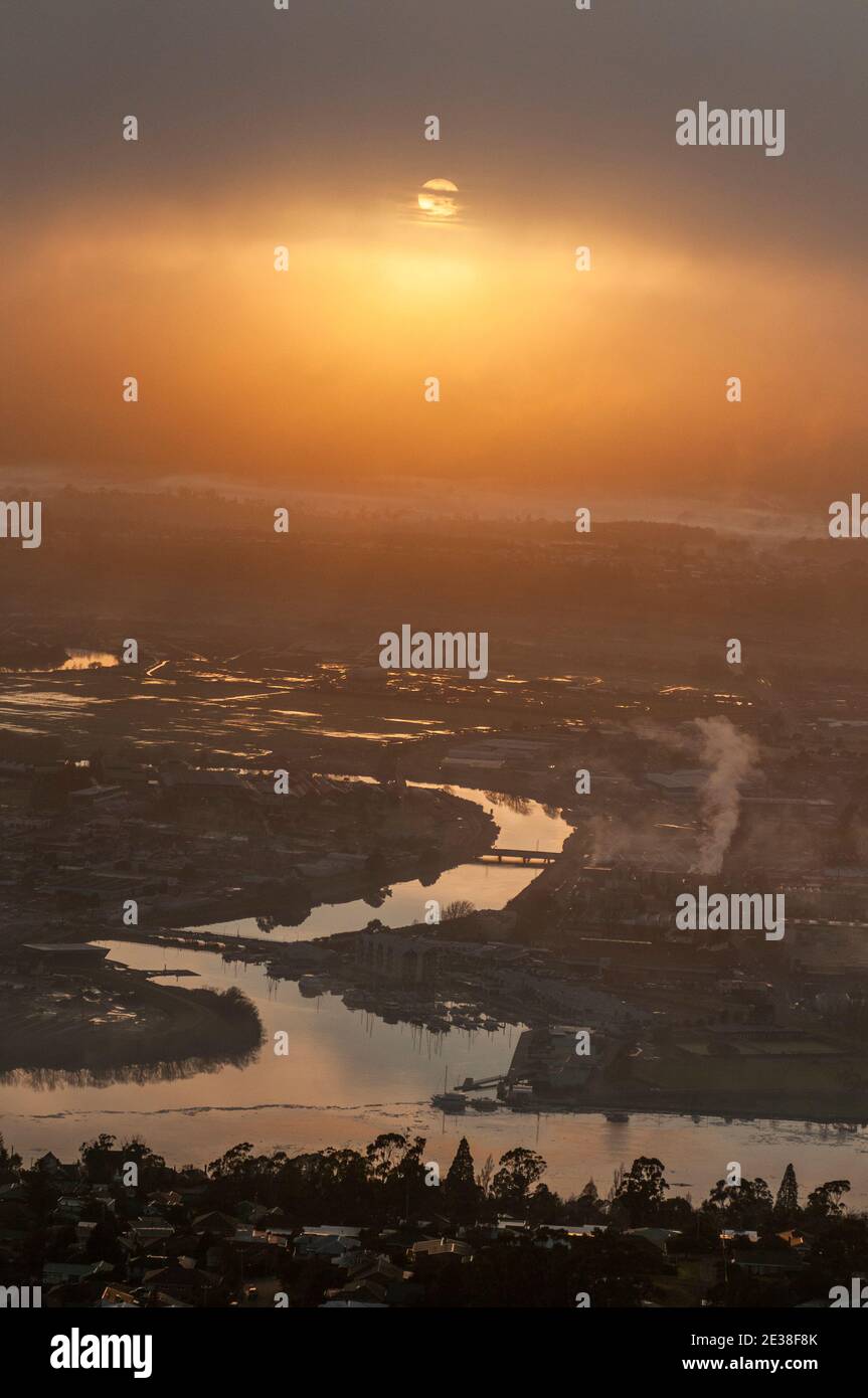An aerial view of Launceston in Tasmania at dawn. The sun rises over ...