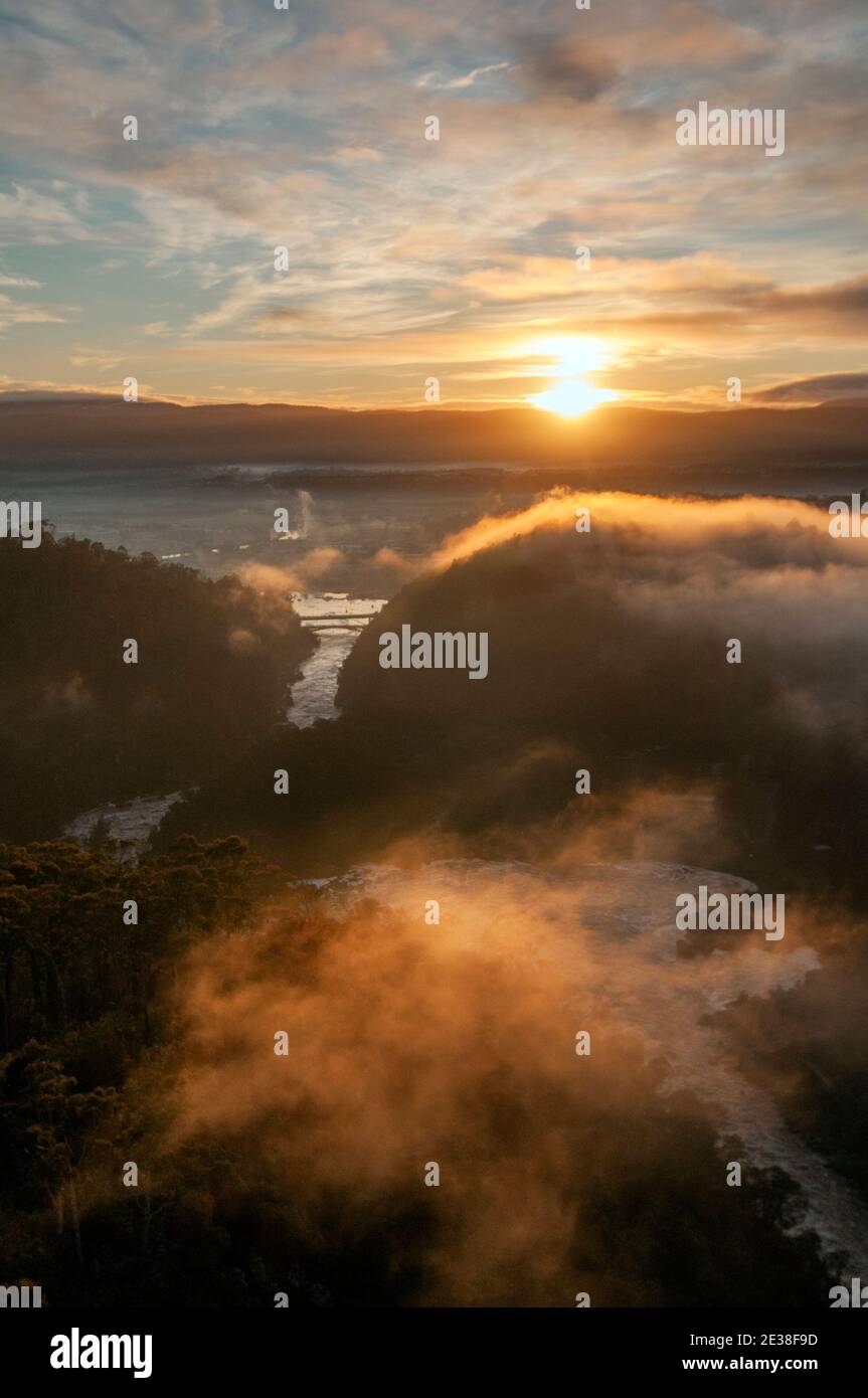 An aerial view of Launceston in Tasmania at dawn. The sun rises over ...