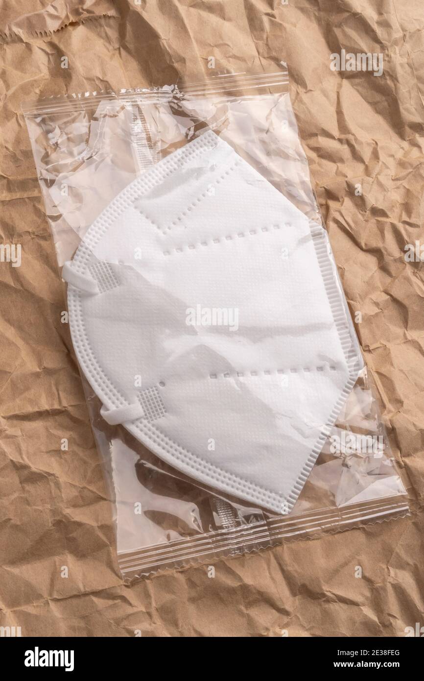 Close-up medical mask KN95 on crumpled wrinkled paper in plastic ...