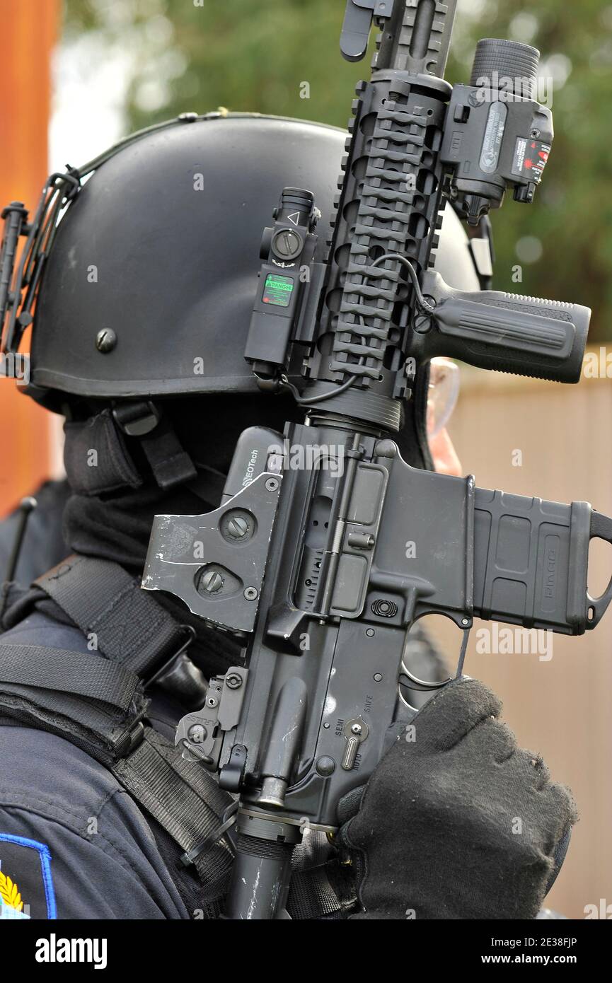 A close up of a Police Tactical Response officer with his laser sighted ...