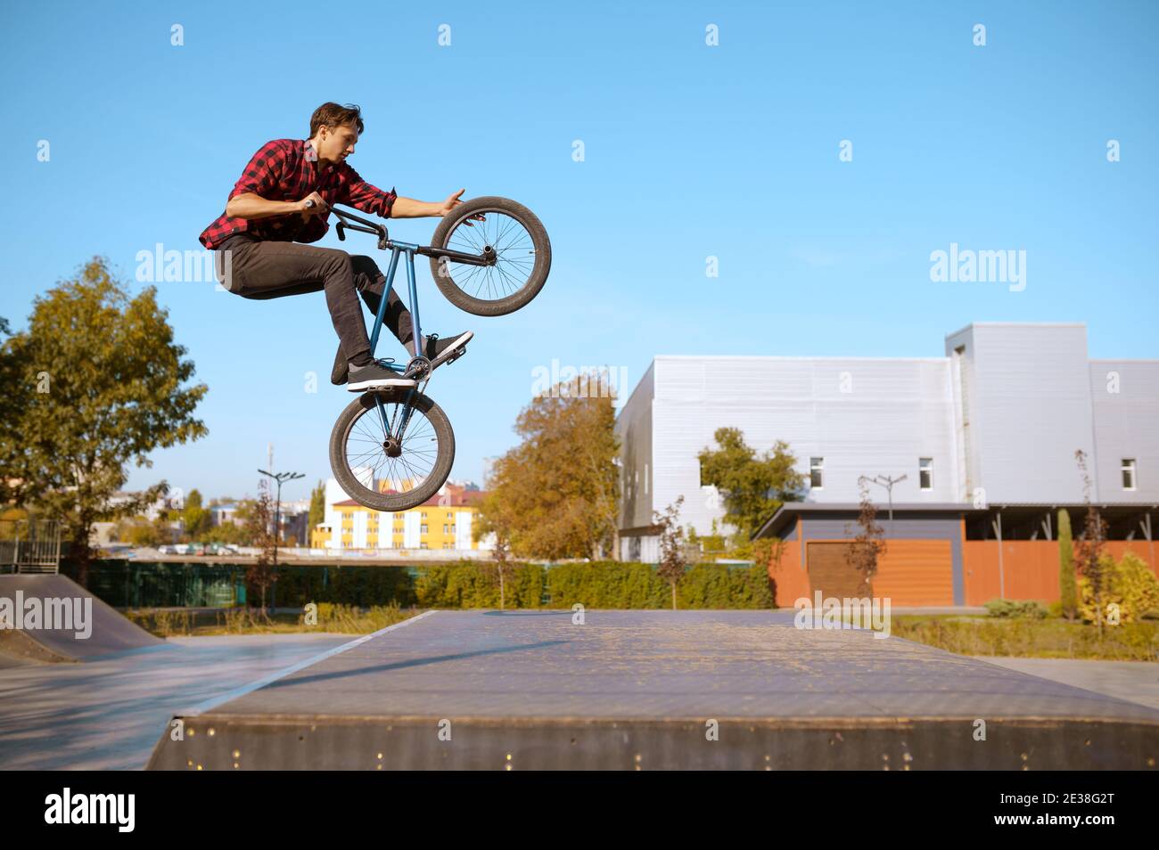 Male bmx biker jumps on ramp in skatepark Stock Photo - Alamy
