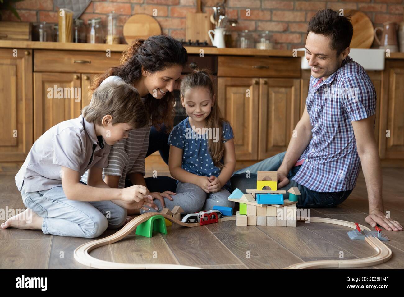 Happy family with kids playing at home together Stock Photo - Alamy