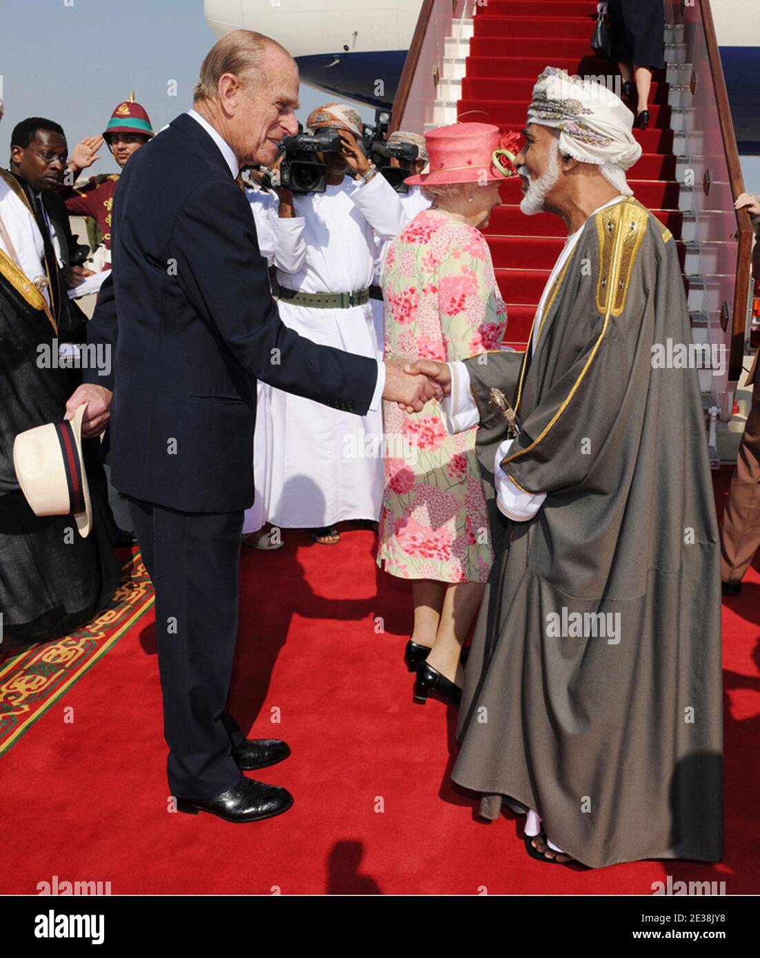 Queen Elizabeth II walks towards her plane with the Sultan of Oman, His ...