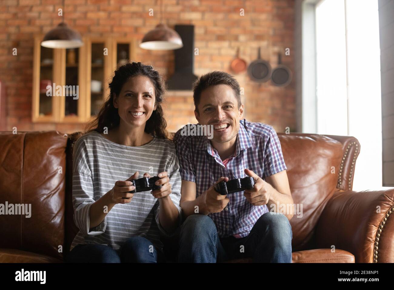 Happy couple have fun playing video games together Stock Photo - Alamy