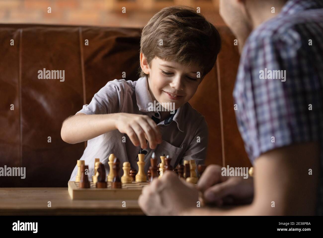 Happy little child play chess with father Stock Photo - Alamy