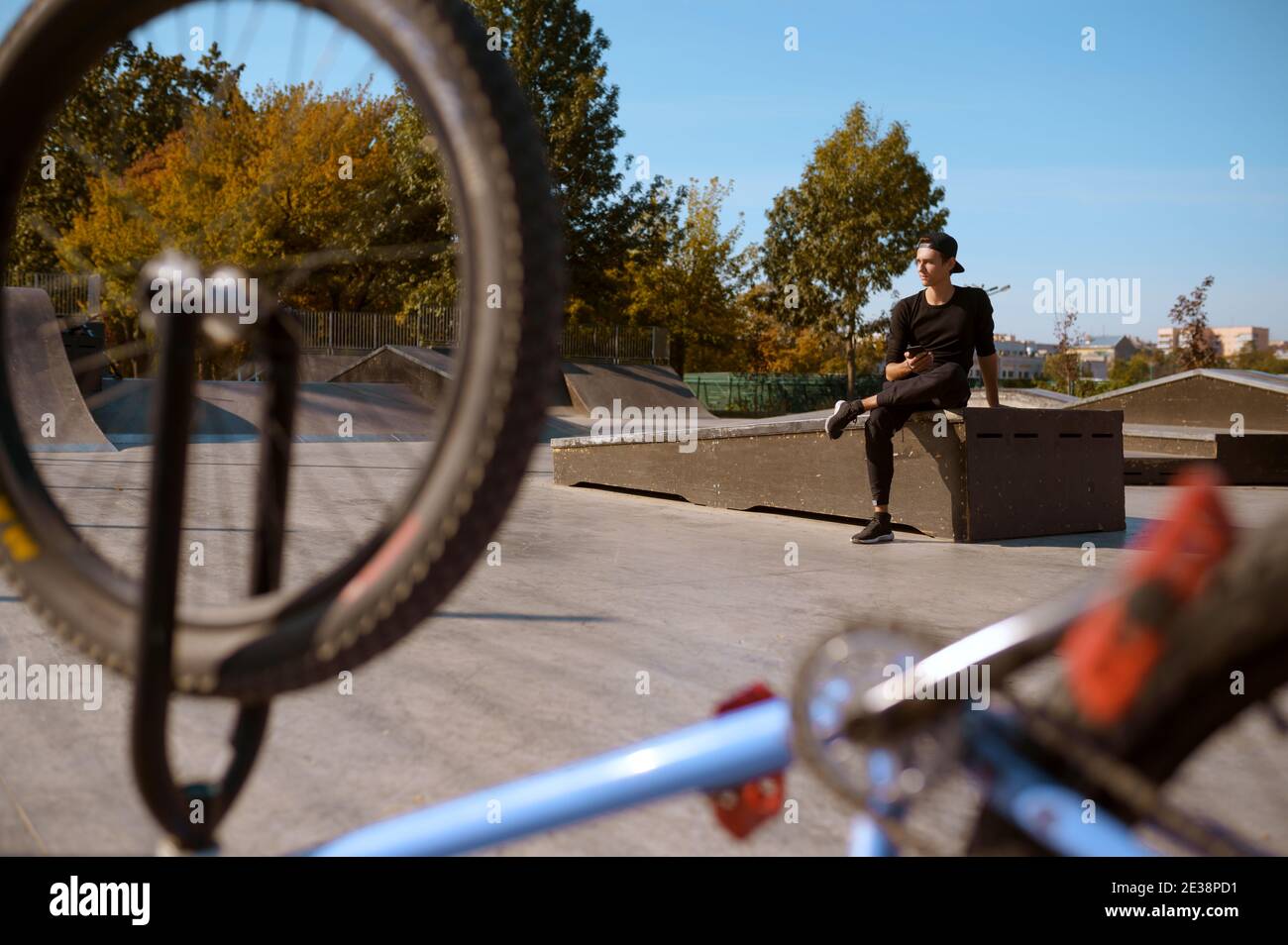 Male bmx rider poses in skatepark at the bike Stock Photo - Alamy