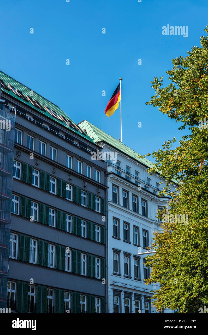 Facade of classic buildings with a German flag on the roof in Hamburg ...