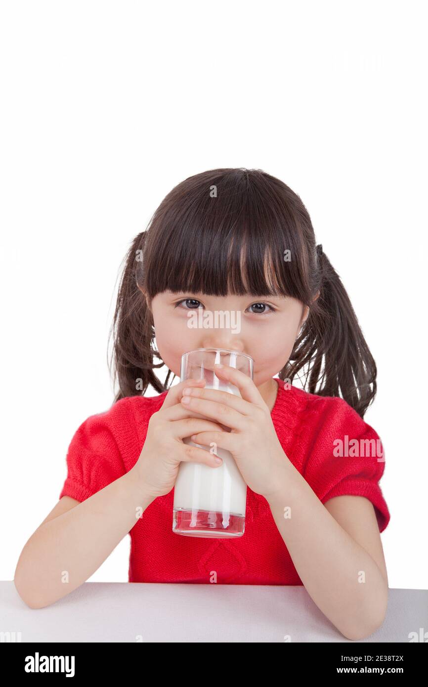 Indian girl drinking glass milk hi-res stock photography and images - Alamy