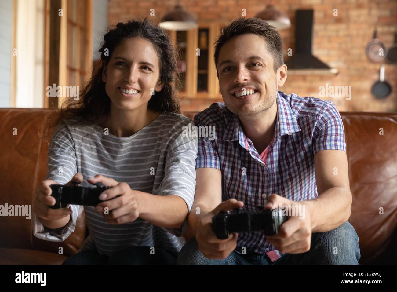 Happy young couple have fun playing video games Stock Photo - Alamy