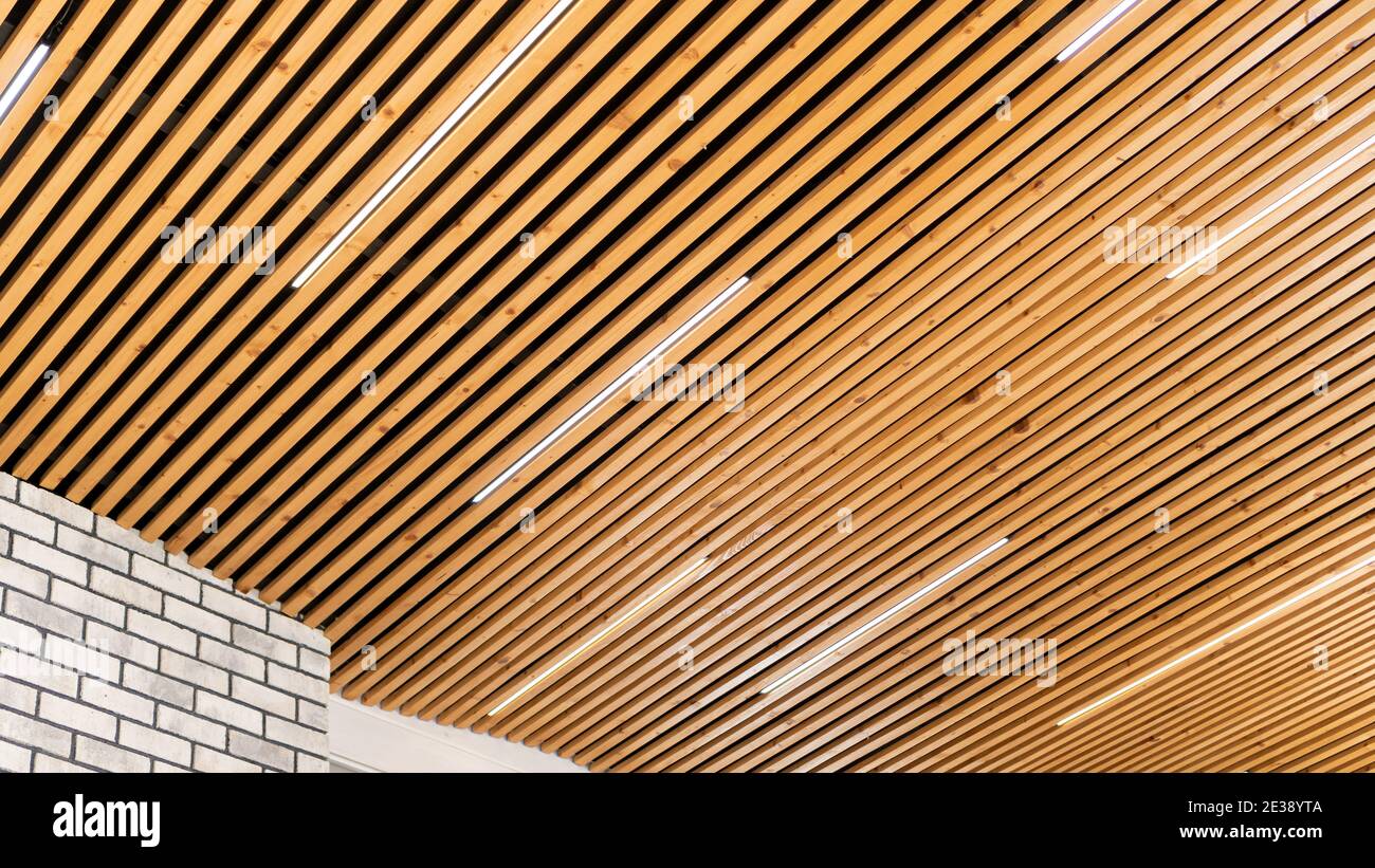 Close-up on a loft-style pine wood plank ceiling combined with white ...