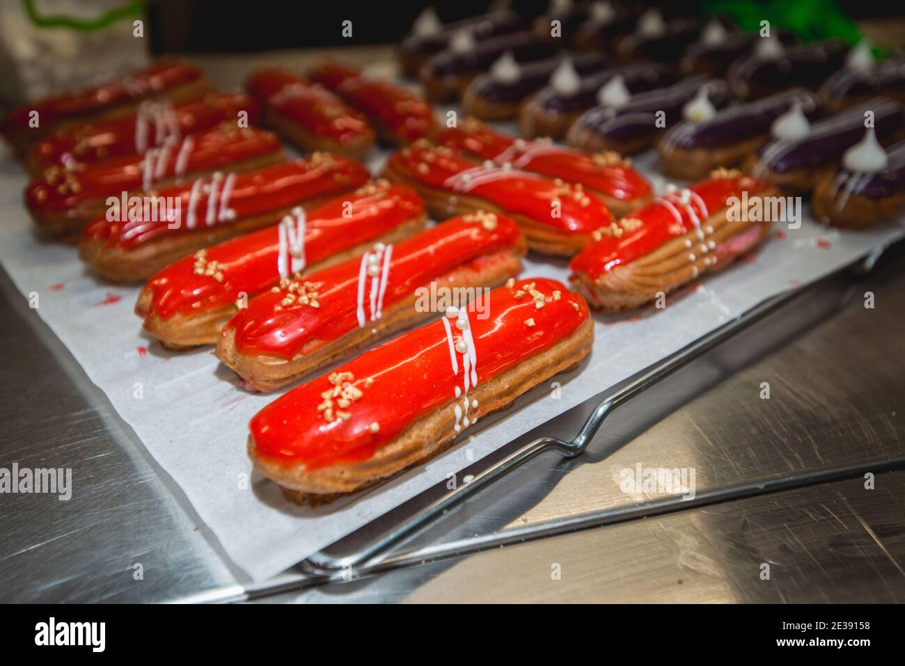 Eclairs with red toppings Stock Photo - Alamy