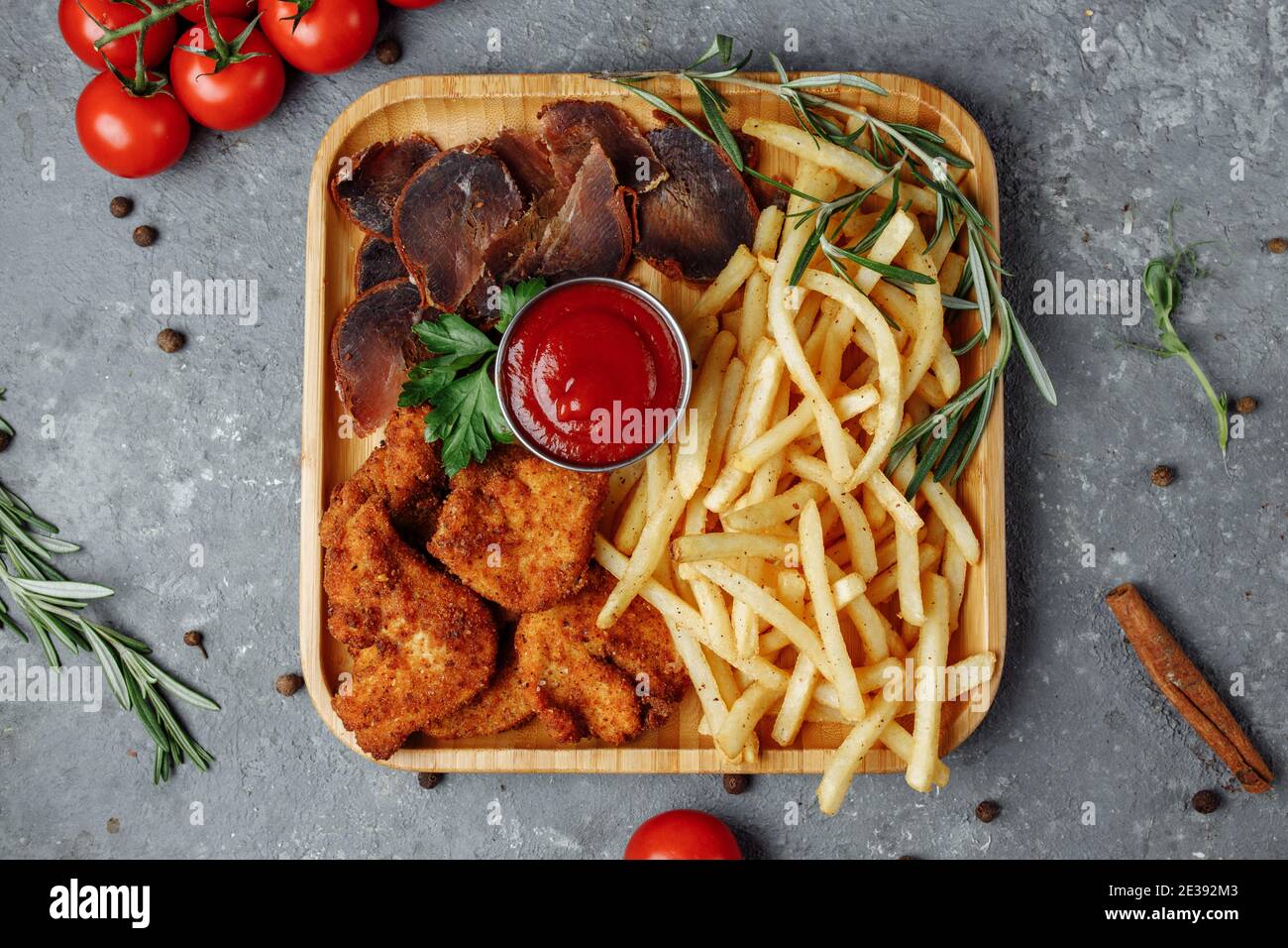 plate with snacks. breaded chicken nuggets, fried potatoes and jamon ...