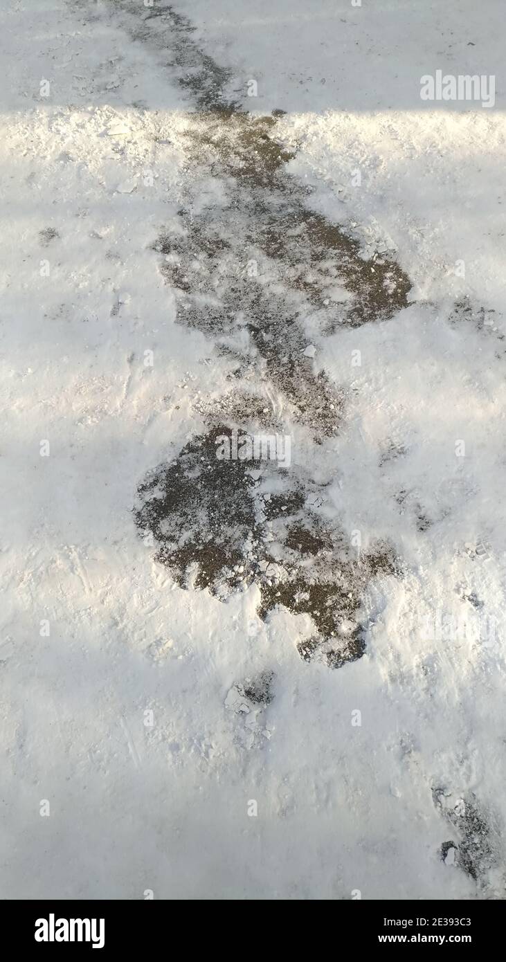 Asphalt road, track partially cleared of snow Stock Photo - Alamy