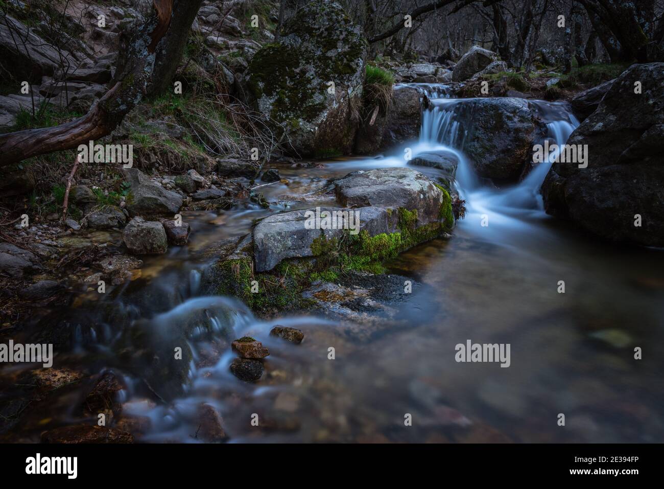 River water flows among the rocks and forms small waterfalls, Rascafría ...