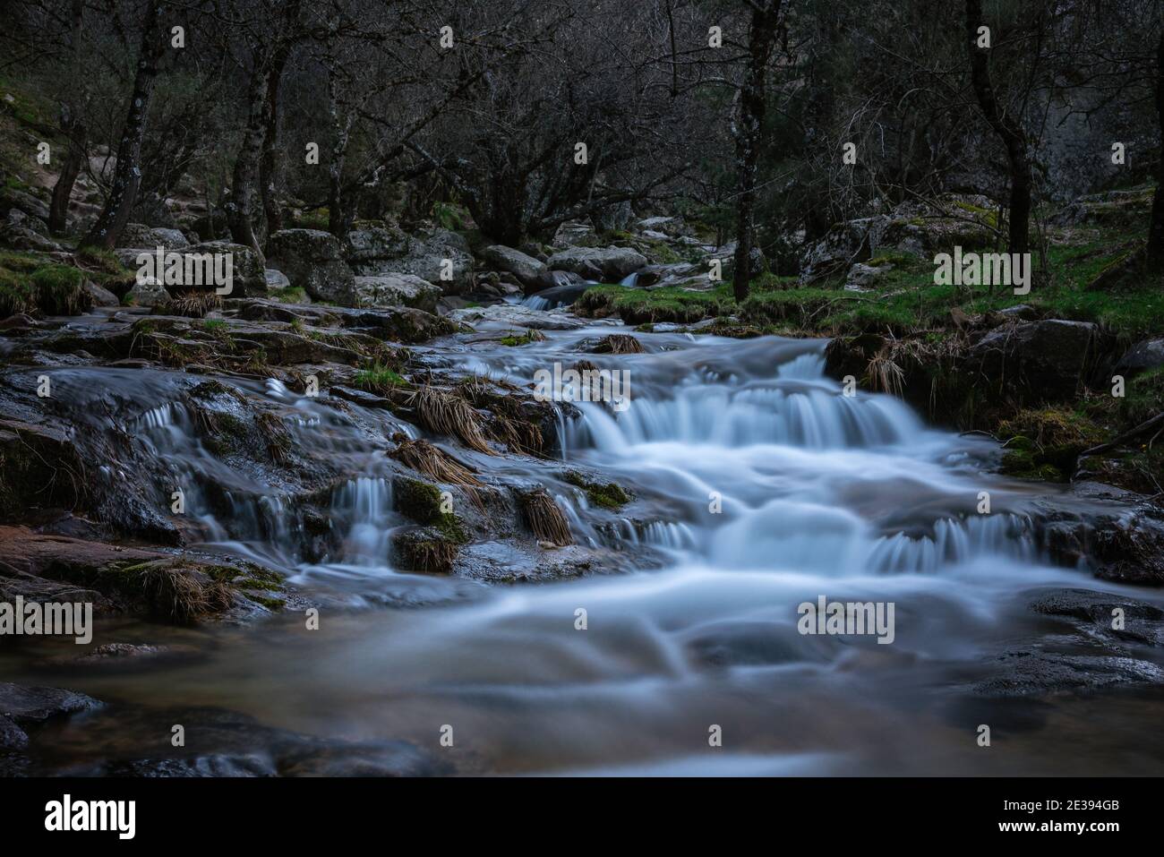 River water flows among the rocks and forms small waterfalls, Rascafría ...