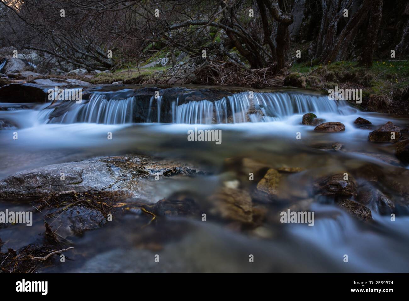 River water flows among the rocks and forms small waterfalls, Rascafría ...