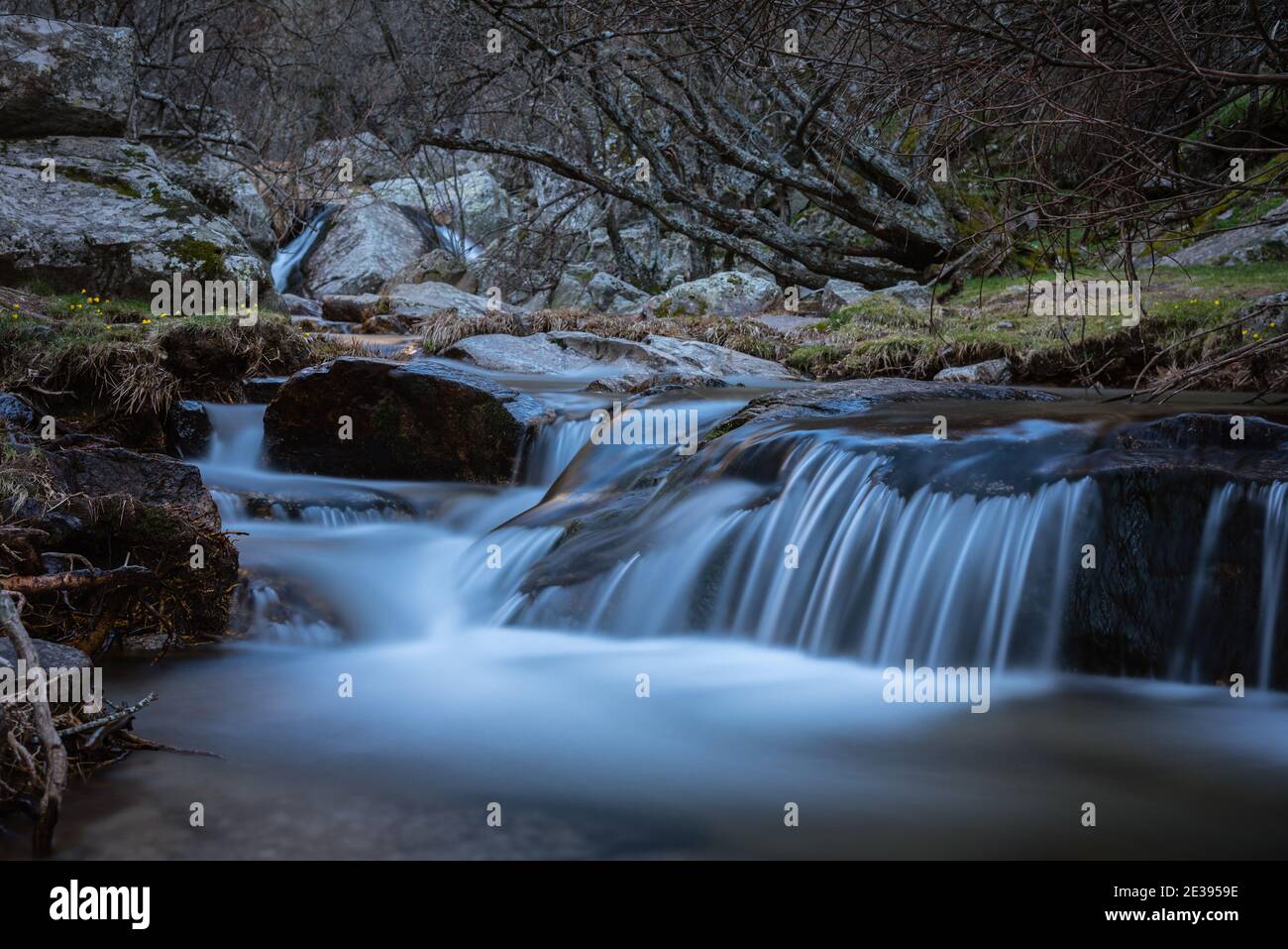River water flows among the rocks and forms small waterfalls, Rascafría ...