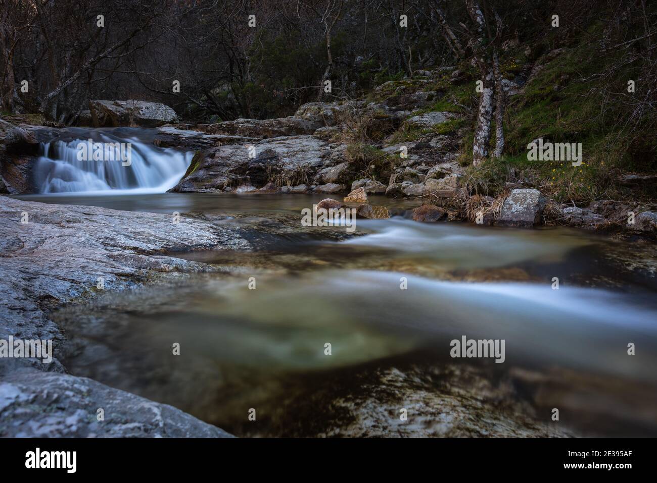 River water flows among the rocks and forms small waterfalls, Rascafría ...
